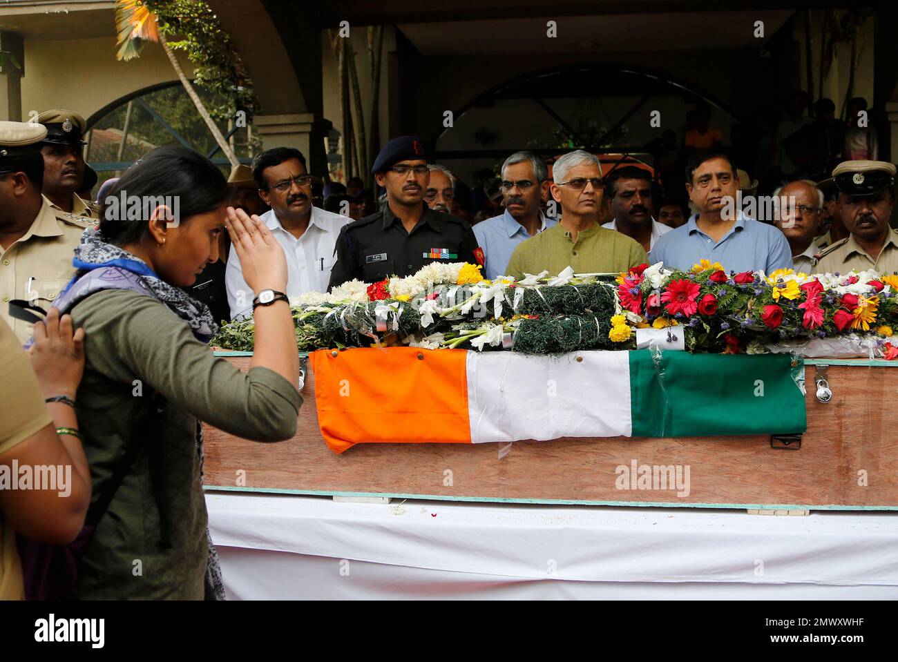 A girl salutes next to the coffin of Indian army officer Akshay Girish ...