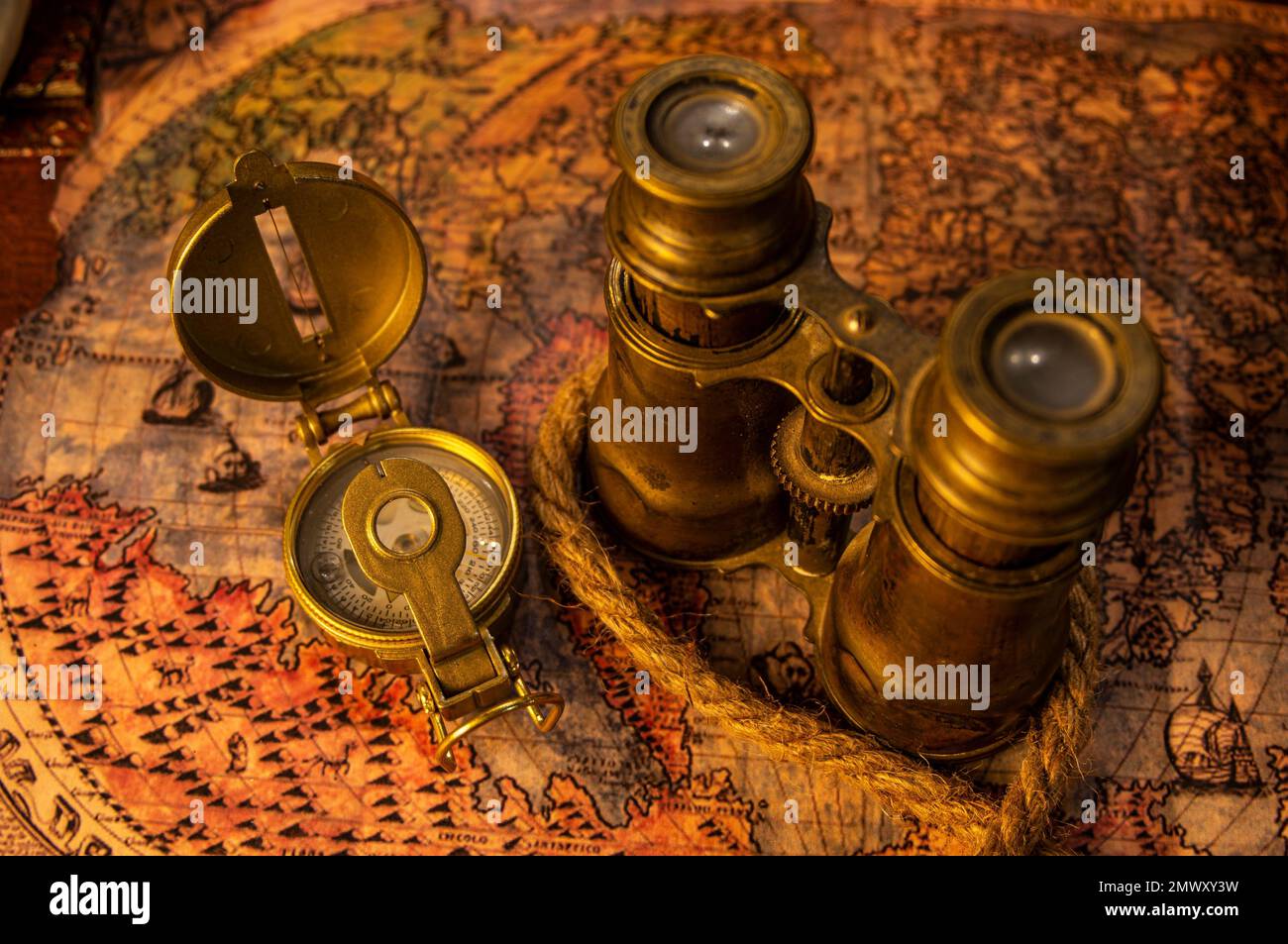 Antique adventure scroll background on adventurer table. Binoculars ...