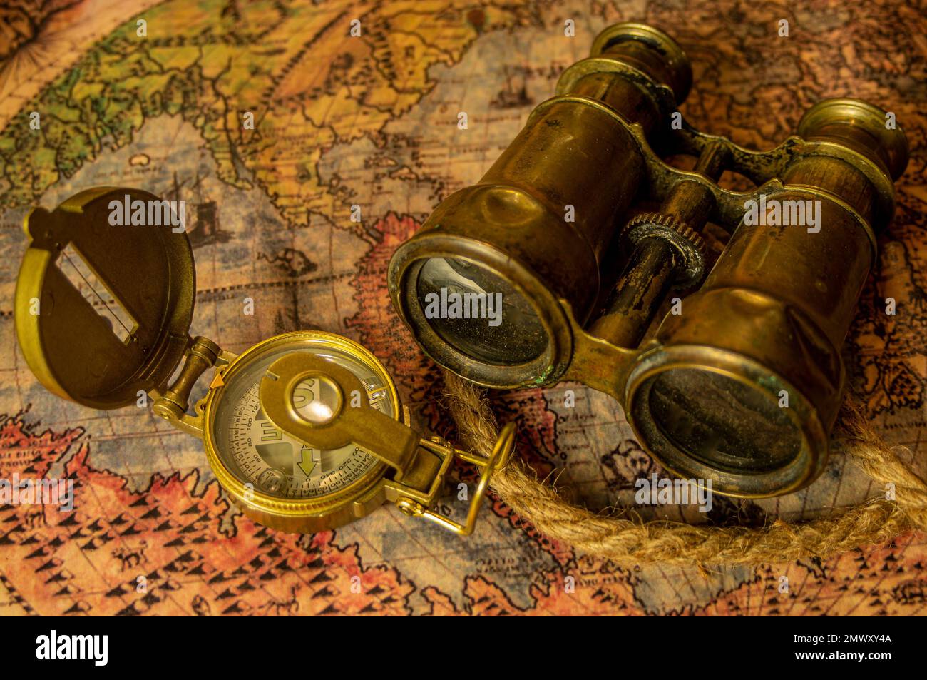 Antique adventure scroll background on adventurer table. Binoculars ...