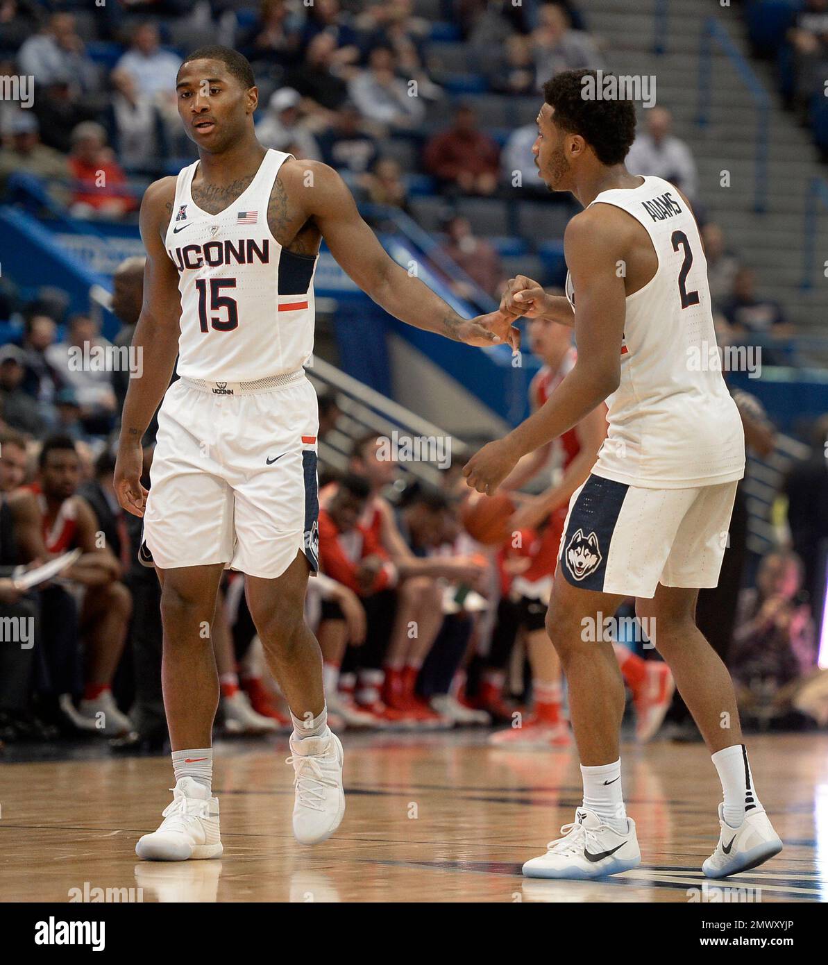 Connecticut's Jalen Adams, right, encourages teammate Rodney Purvis ...