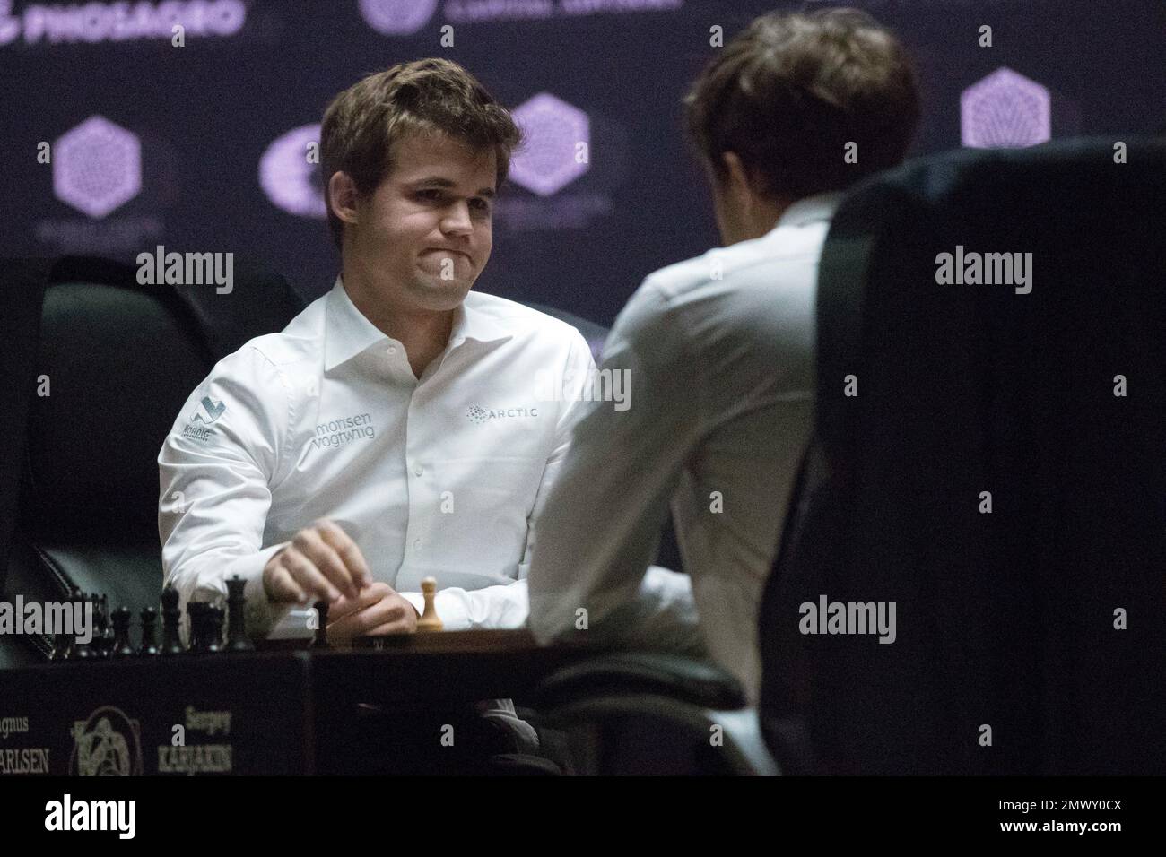 Defending champion Magnus Carlsen, left, reacts after Sergey Karjakin ...