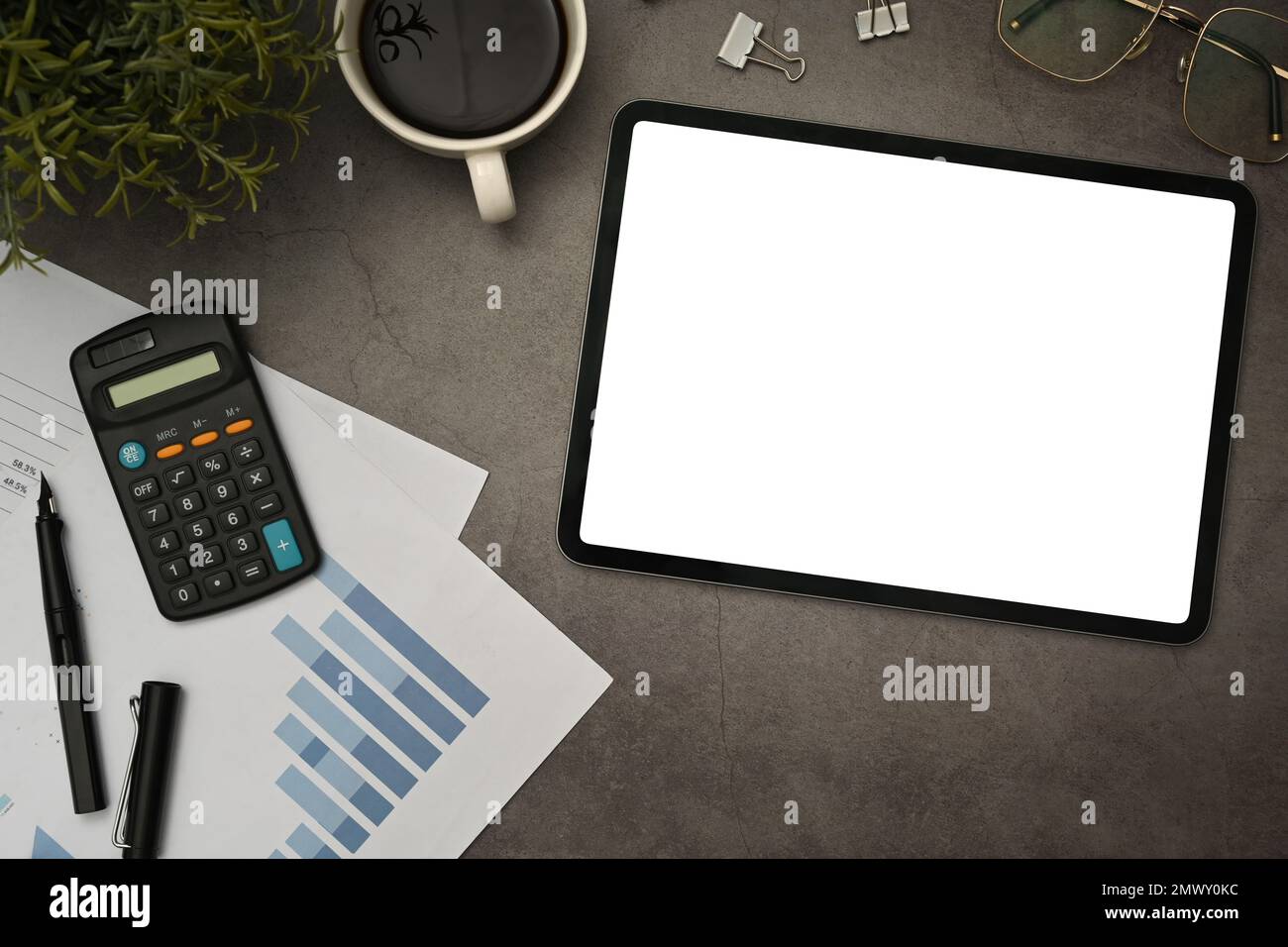 Tablet with empty display, calculator, financial reports and supplies ...