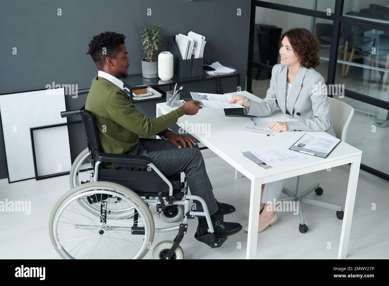 High angle view of businesswoman having job interview with man with ...