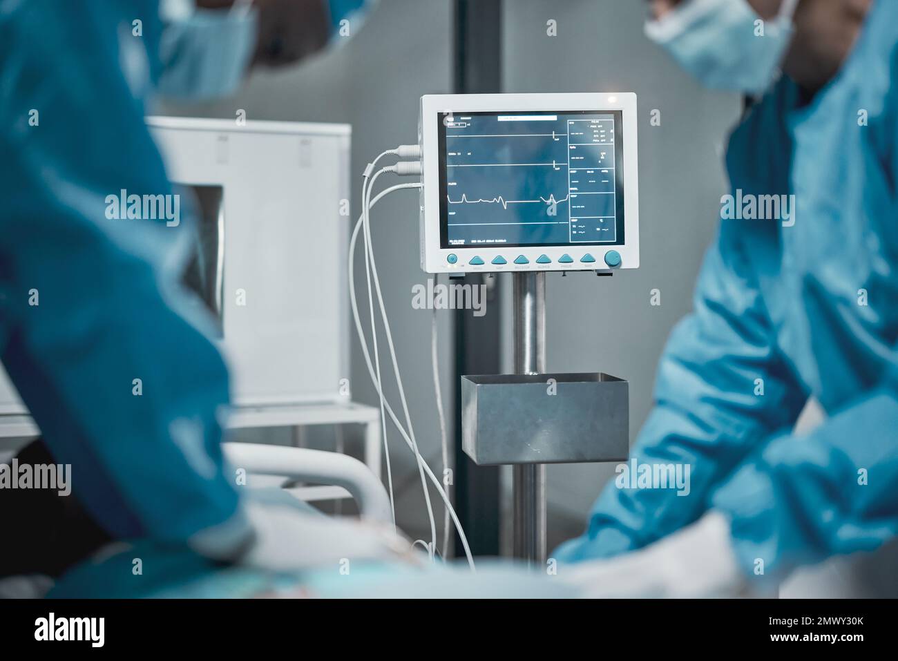 Monitor, electrocardiogram and doctors in surgery, healthcare and ...