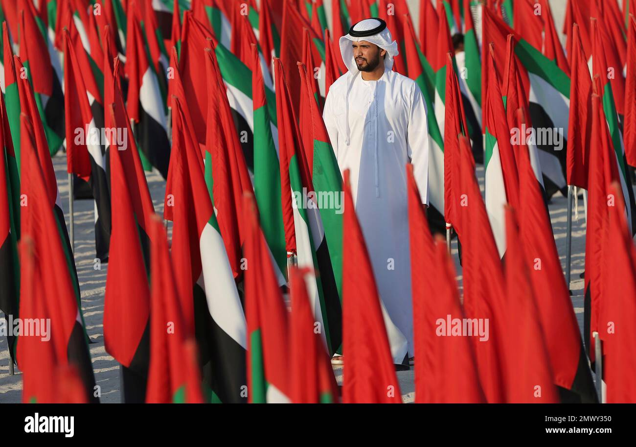 An Emirati man walks inside the "Flags Garden" featuring 4,000 UAE ...