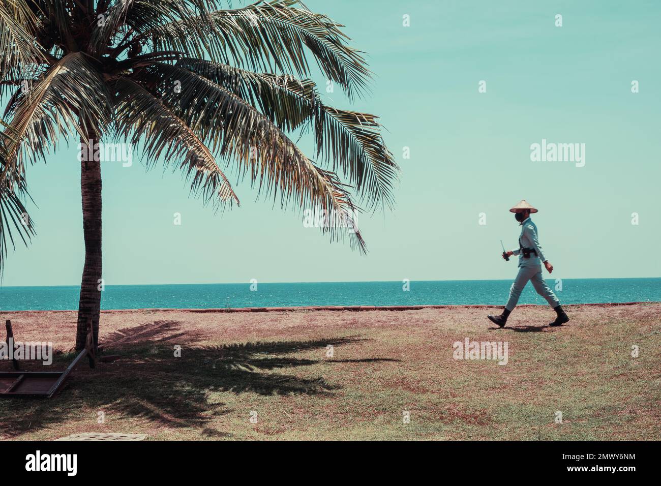 Guard dressed in colonial-era uniform walking across a beach Stock ...