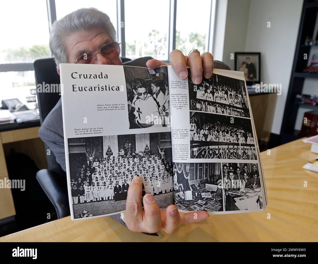 Cuban exile Max Alvarez, 68, shows a reporter black-and-white photos of ...