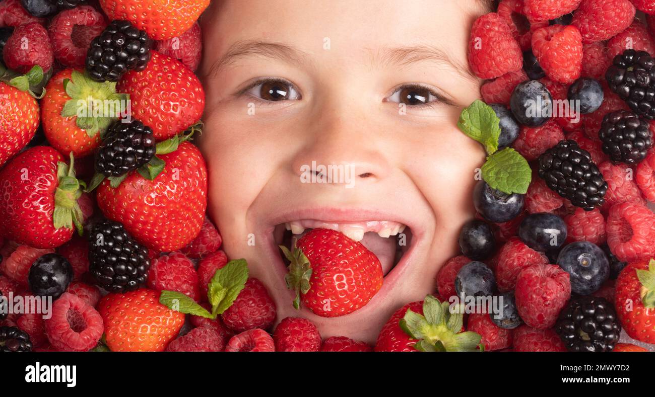 Fruits set. Child face with berry frame, close up. Berries mix ...