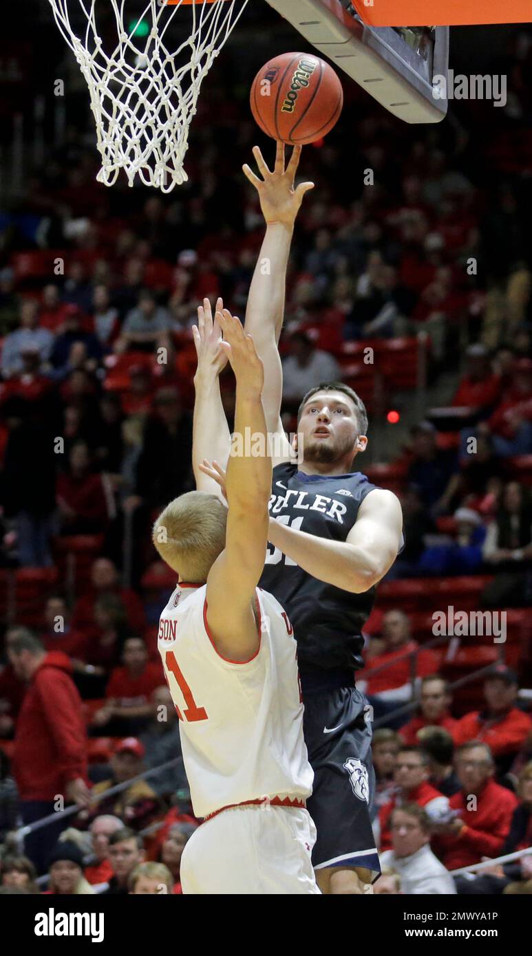 Butler center Nate Fowler, rear, shoots as Utah forward Tyler Rawson ...