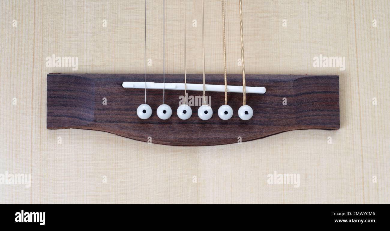 Musical instrument - Closeup top view bridge acoustic guitar, pins and ...