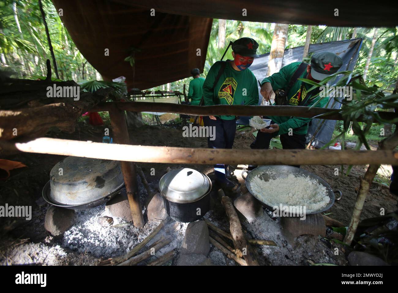 In this Nov. 23, 2016 photo, New People's Army guerrillas with faces ...