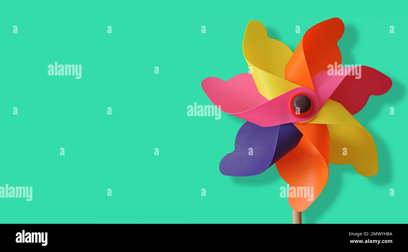 Flat lay Rainbow pinwheel on green background, copy space Stock Photo ...