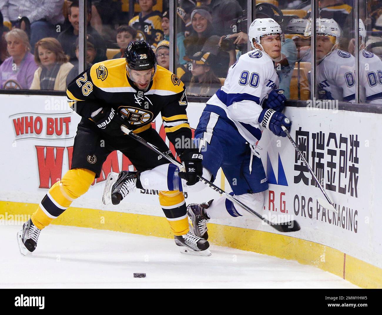 Boston Bruins' Dominic Moore (28) checks Tampa Bay Lightning's ...