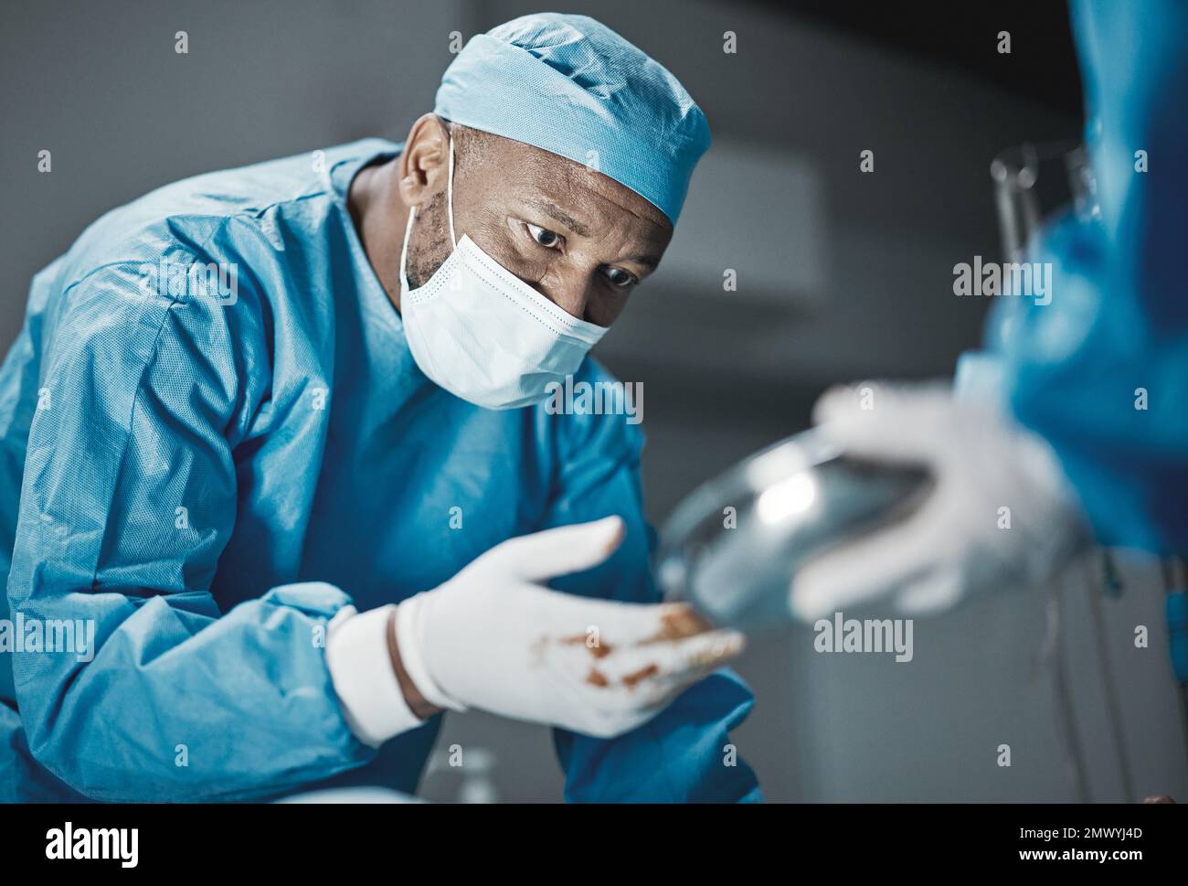 Doctor, surgery and hospital theater with patient and black man surgeon ...