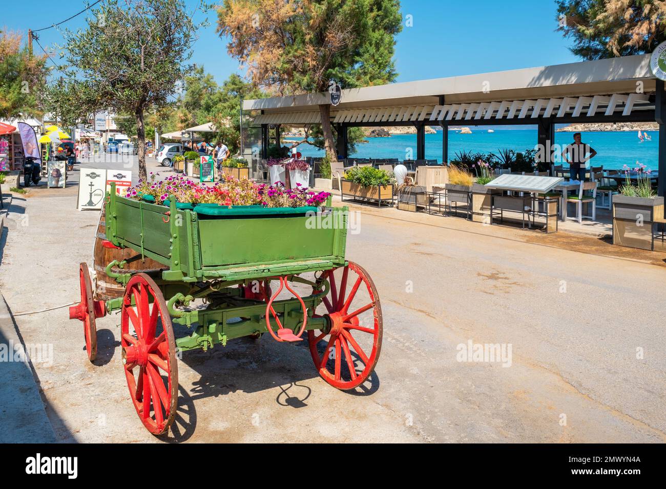 View to main street of the picturesque seaside village Almyrida. Crete ...