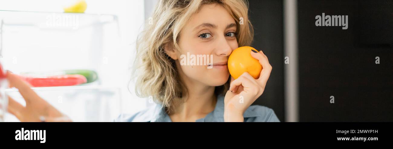 Woman smelling orange fruit hi-res stock photography and images - Alamy
