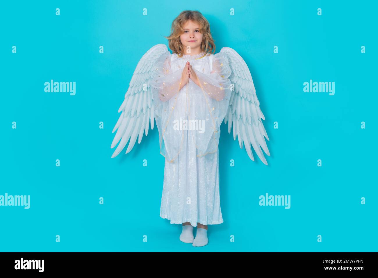 Angel prayer. Cute angel child, studio portrait. Angel kid with angels ...