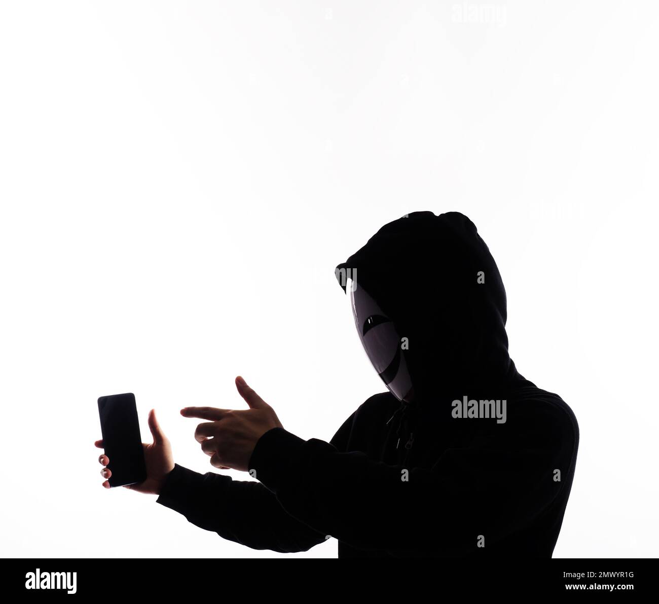 Hacker Anonymous and face mask with smartphone in hand. Man in black ...