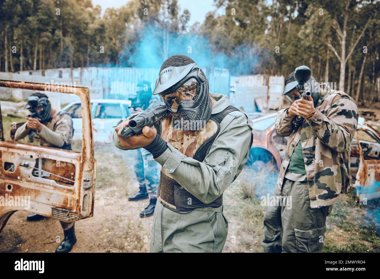 Teamwork, paintball and sports with people in field for hero, target ...