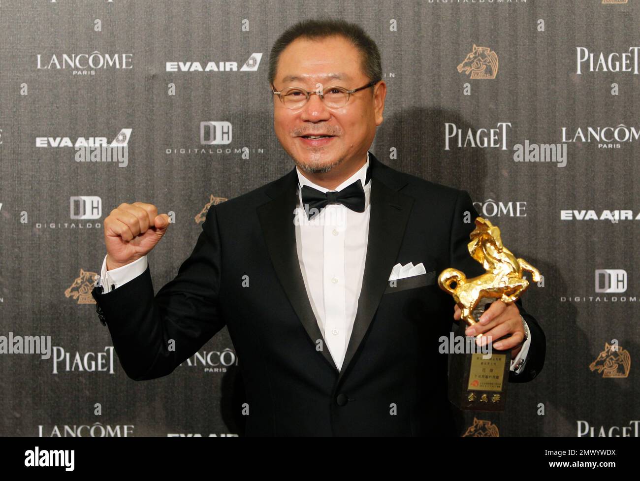 Chinese actor Fan Wei holds his award for Best Leading Actor at the ...