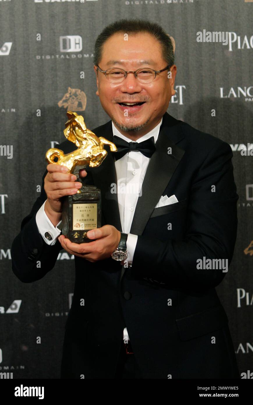 Chinese actor Fan Wei holds his award for Best Leading Actor at the ...
