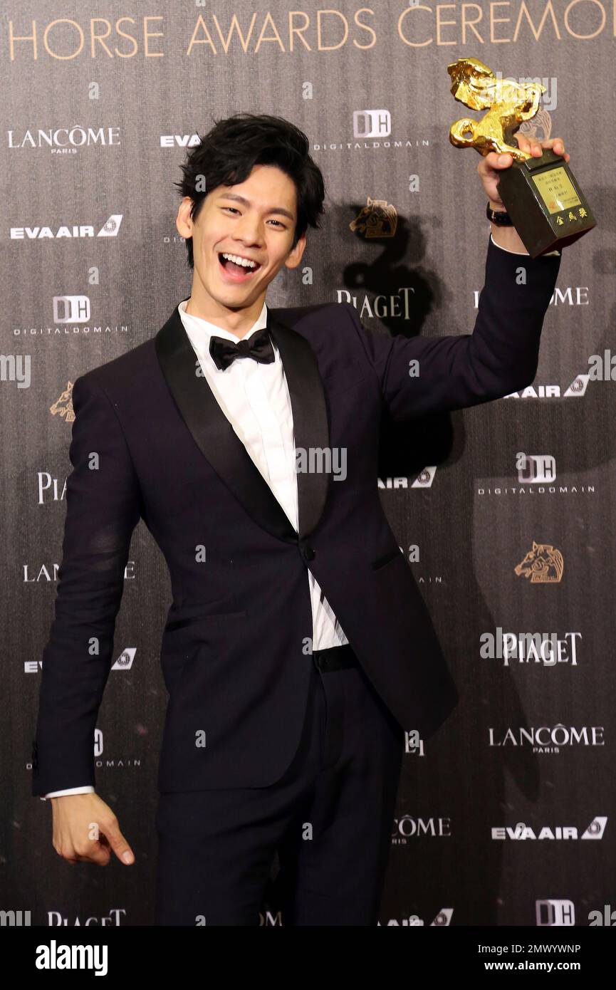 Taiwanese actor Lin Po-hung holds his award for Best Supporting Actor ...