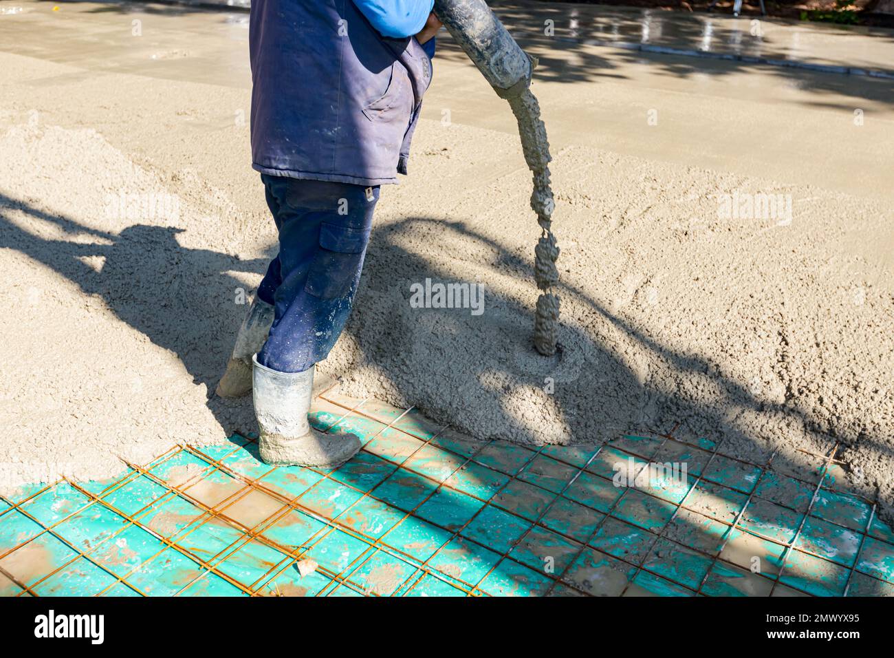 Construction worker is directing the pump tube on right direction ...