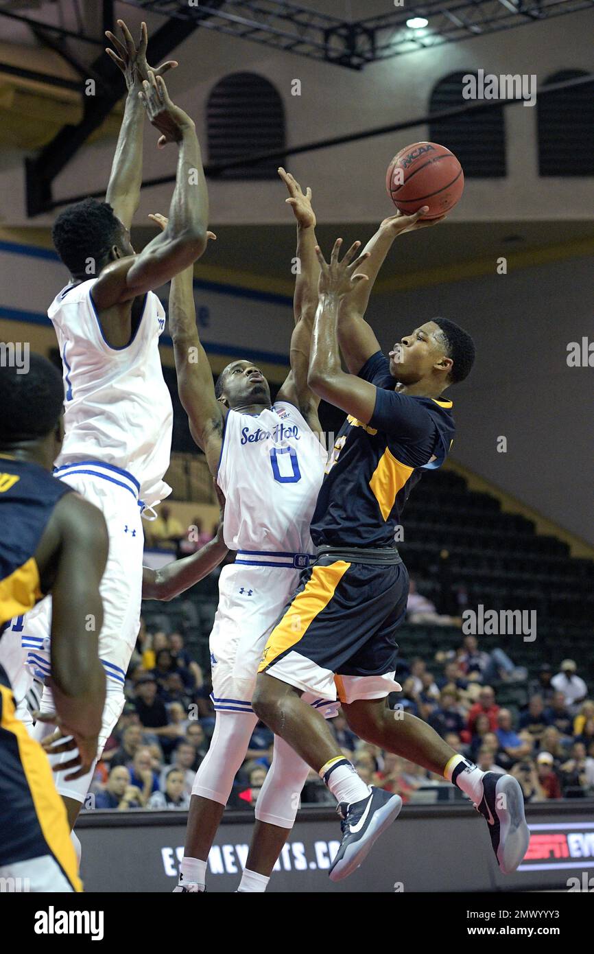 Quinnipiac guard Reggie Oliver (2), right, goes up for a shot in front ...