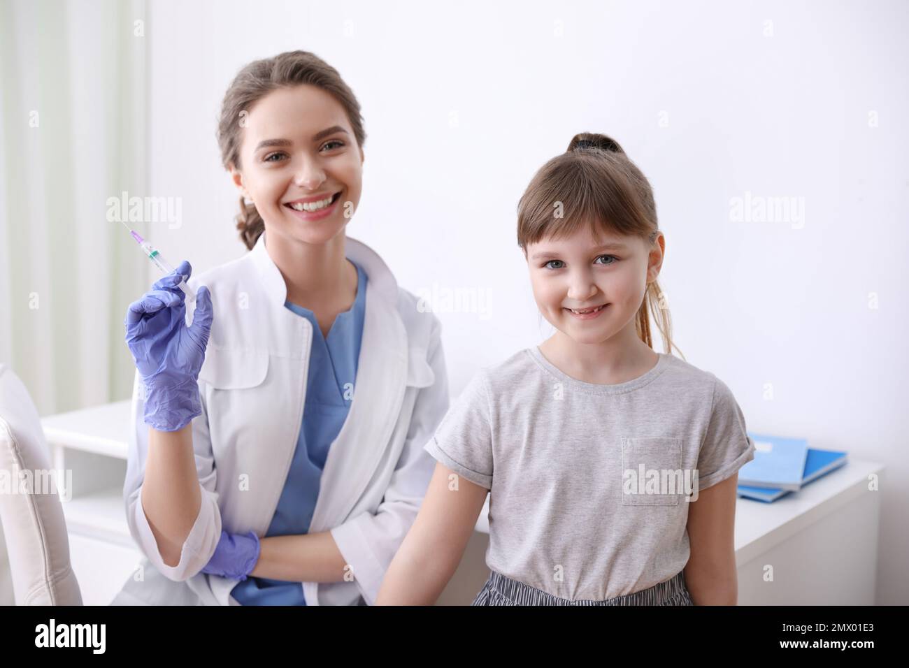 Little girl receiving chickenpox vaccination in clinic. Varicella virus ...
