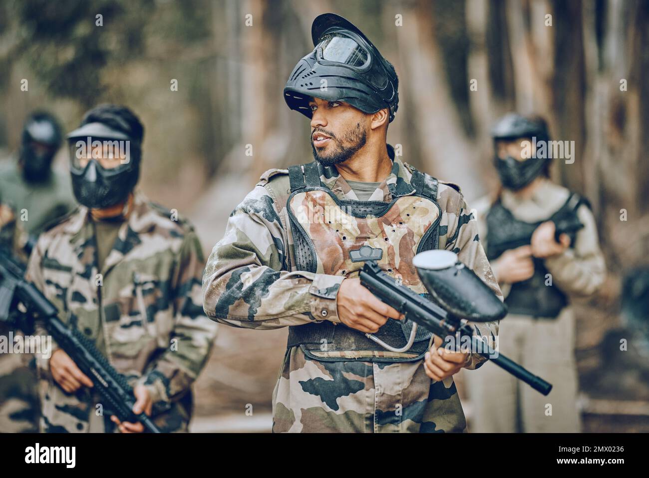 Paintball, sports and team with gun in woods ready for games, arena ...