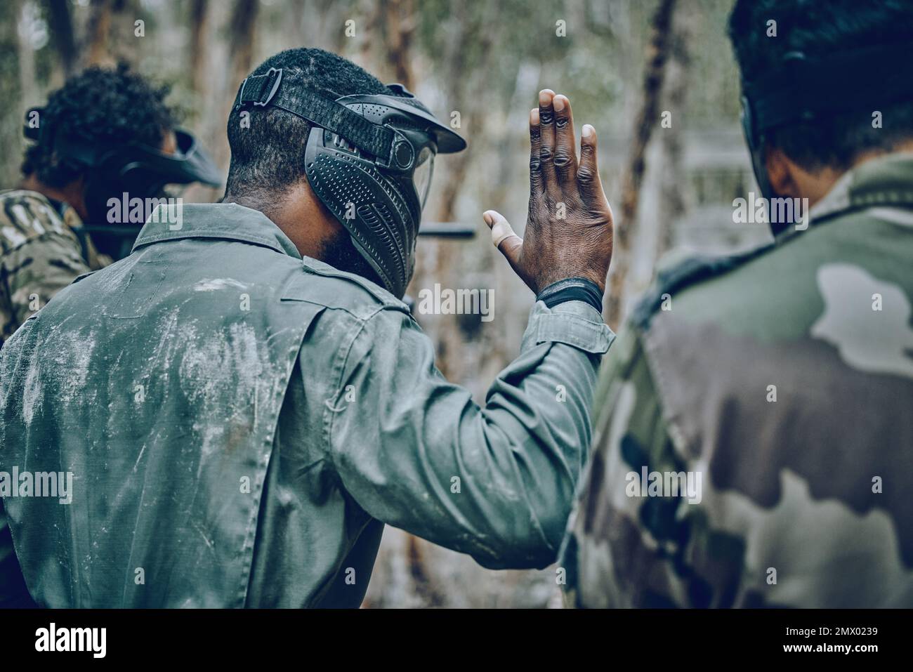 Hand sign, stop and men in training, paintball and planning, strategy ...