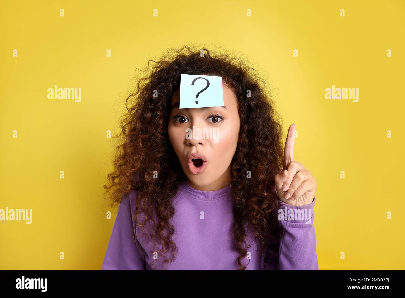 Emotional African-American woman with question mark sticker on forehead ...
