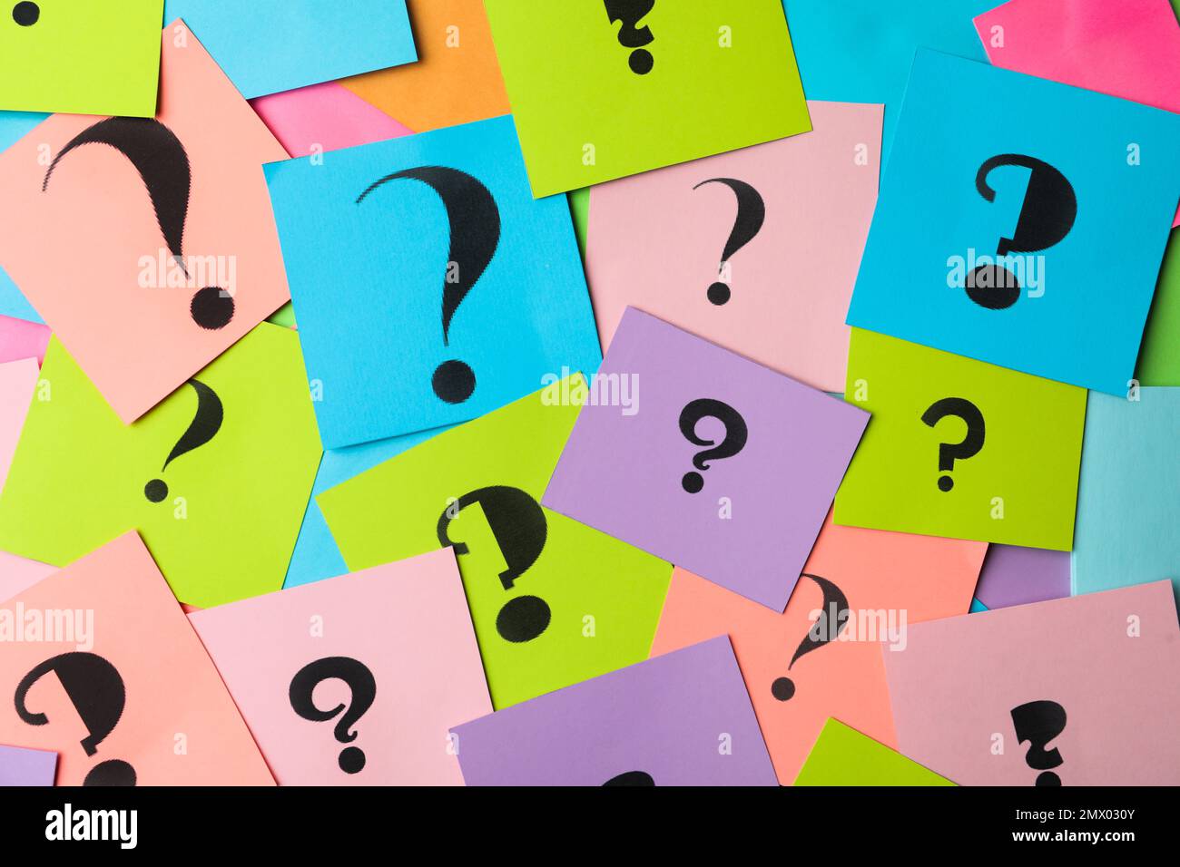 Different colorful paper cards with question marks as background, top ...
