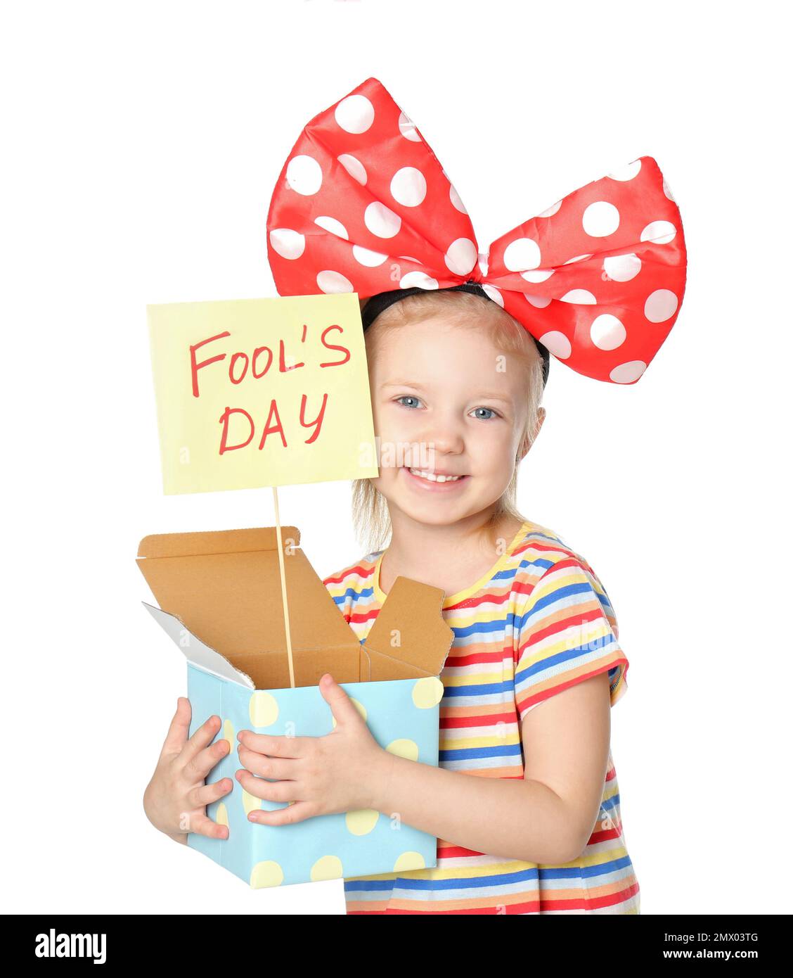 Little girl with large bow and April fool's day sign on white ...