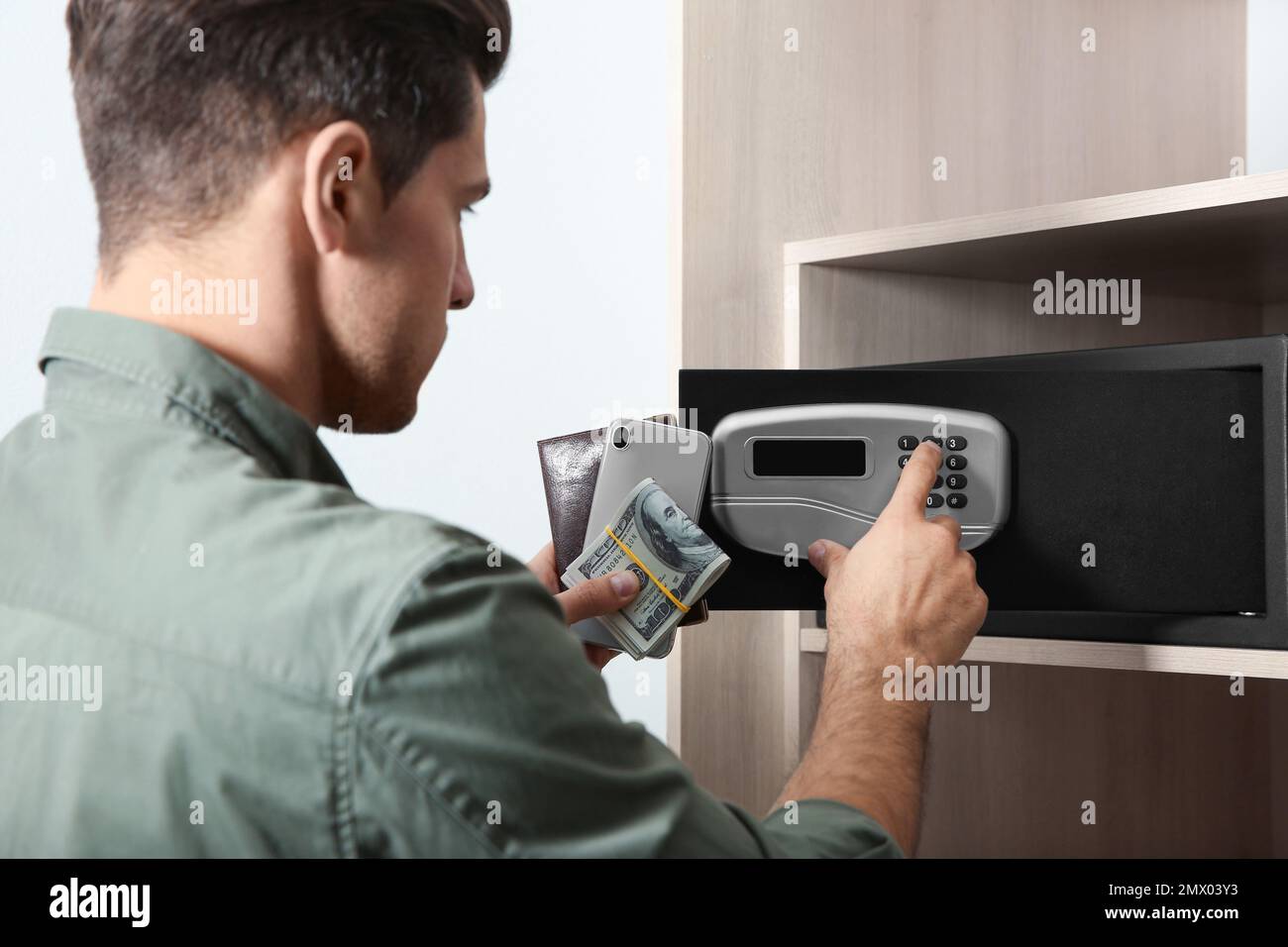 Man opening black steel safe with electronic lock at hotel Stock Photo ...