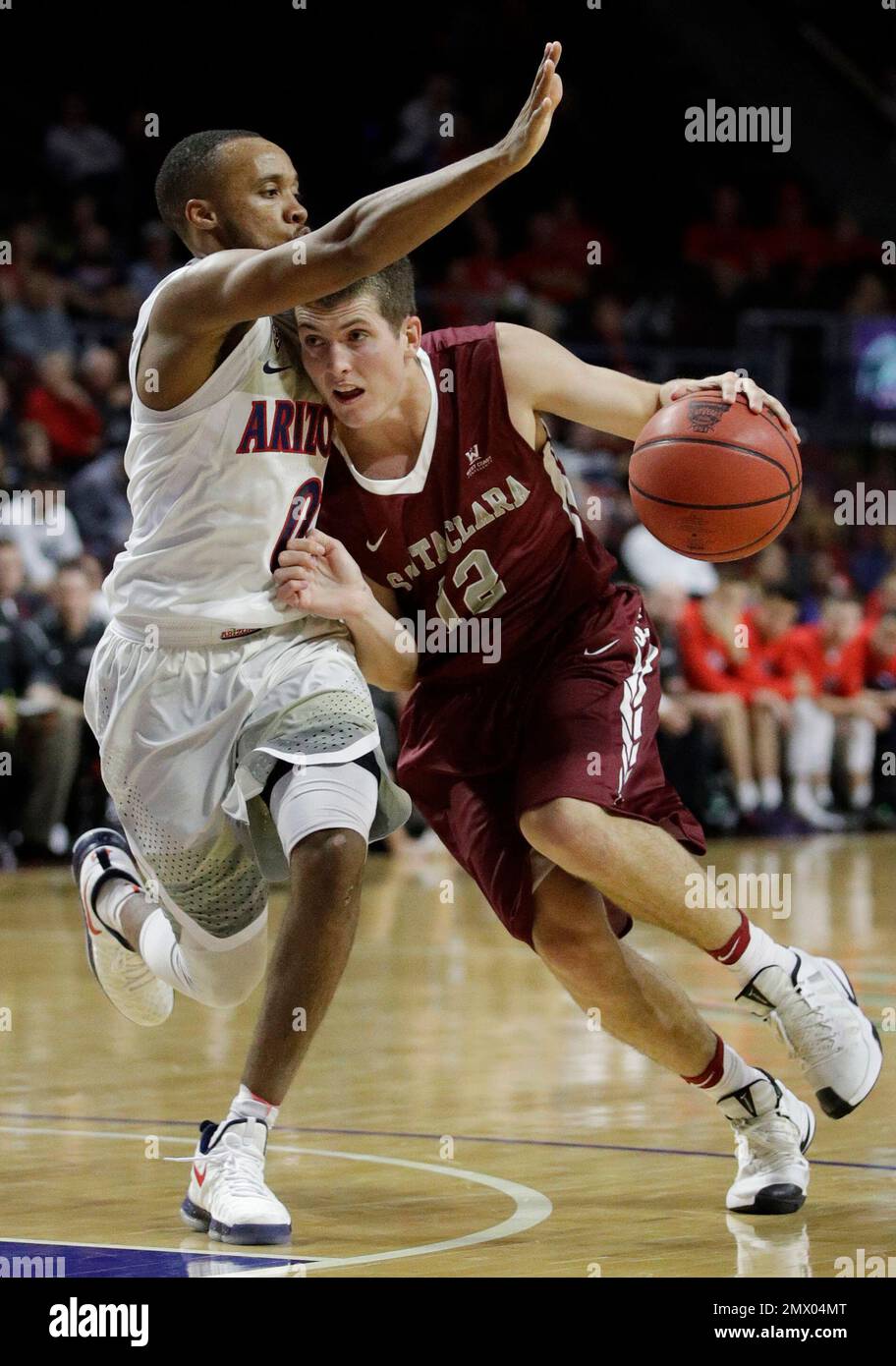 Santa Clara's Matt Hauser drives into Arizona's Parker Jackson ...