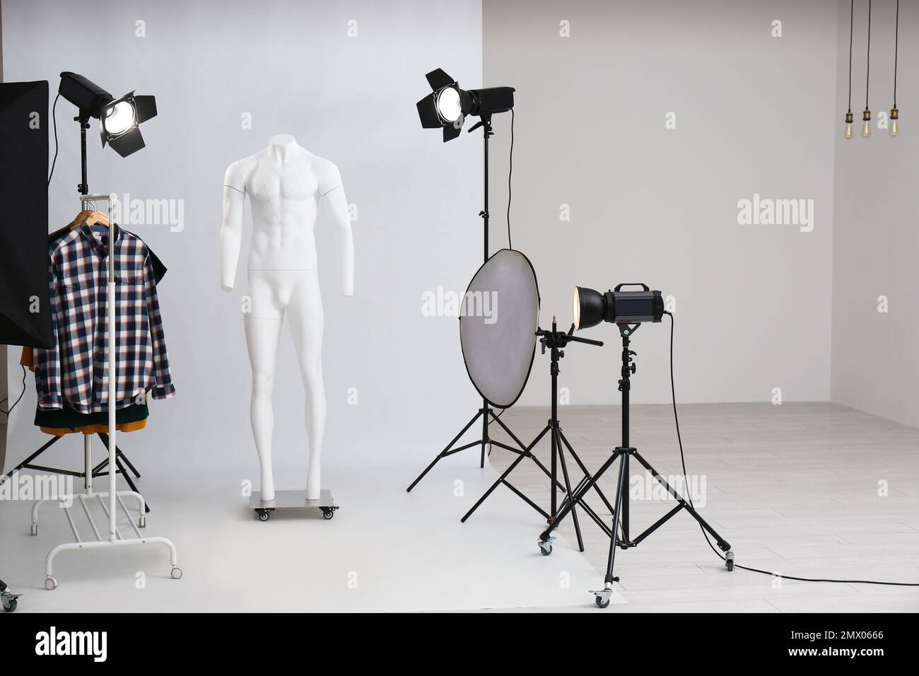 Ghost mannequin and rack with clothes in professional photo studio ...