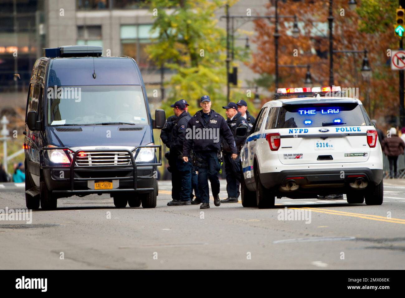 NYPD police officers patrol the parade route on 59th Street during the ...
