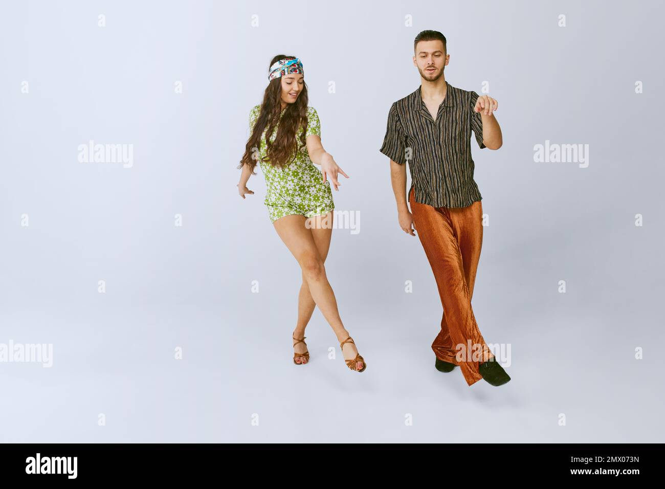 Step by step. Young talented disco dancers, man and woman, in stylish ...