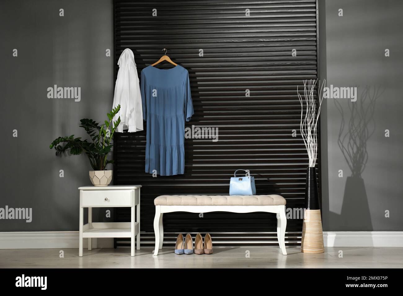Hallway interior with bench, clothes and little cabinet Stock Photo - Alamy