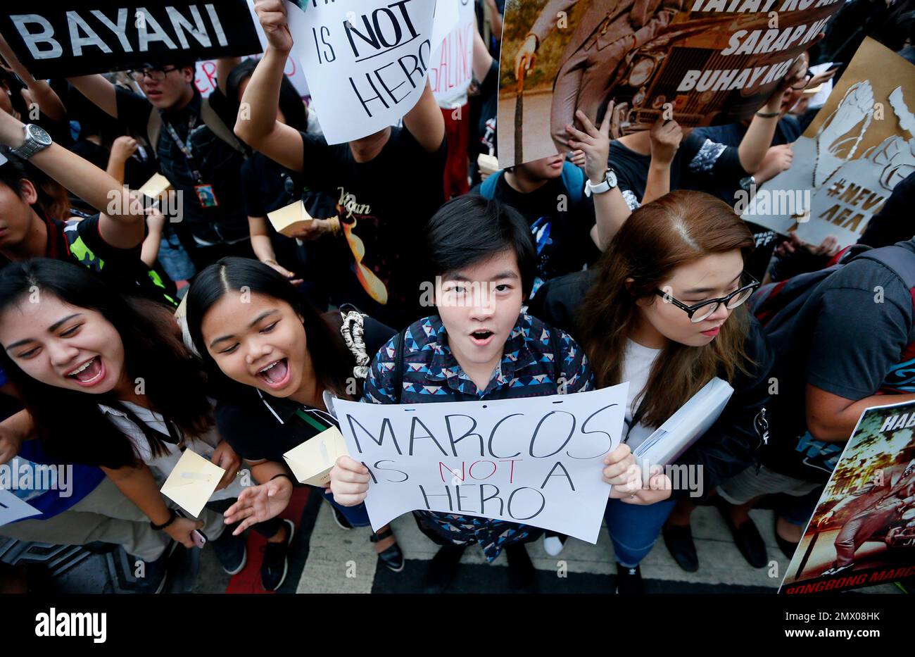 Students shout slogans while displaying placards during a "noise ...