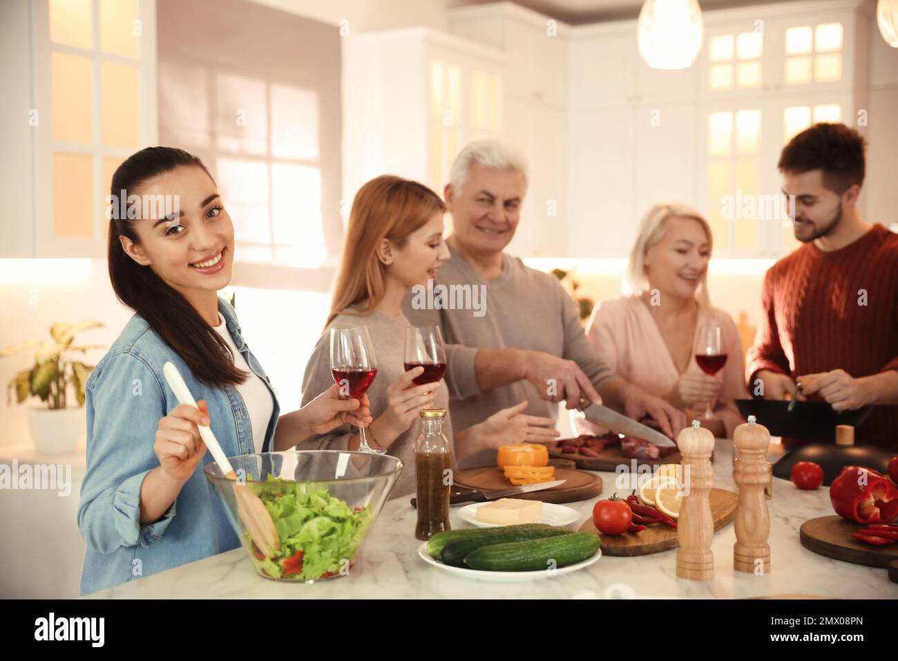 Happy people cooking food together in kitchen Stock Photo - Alamy