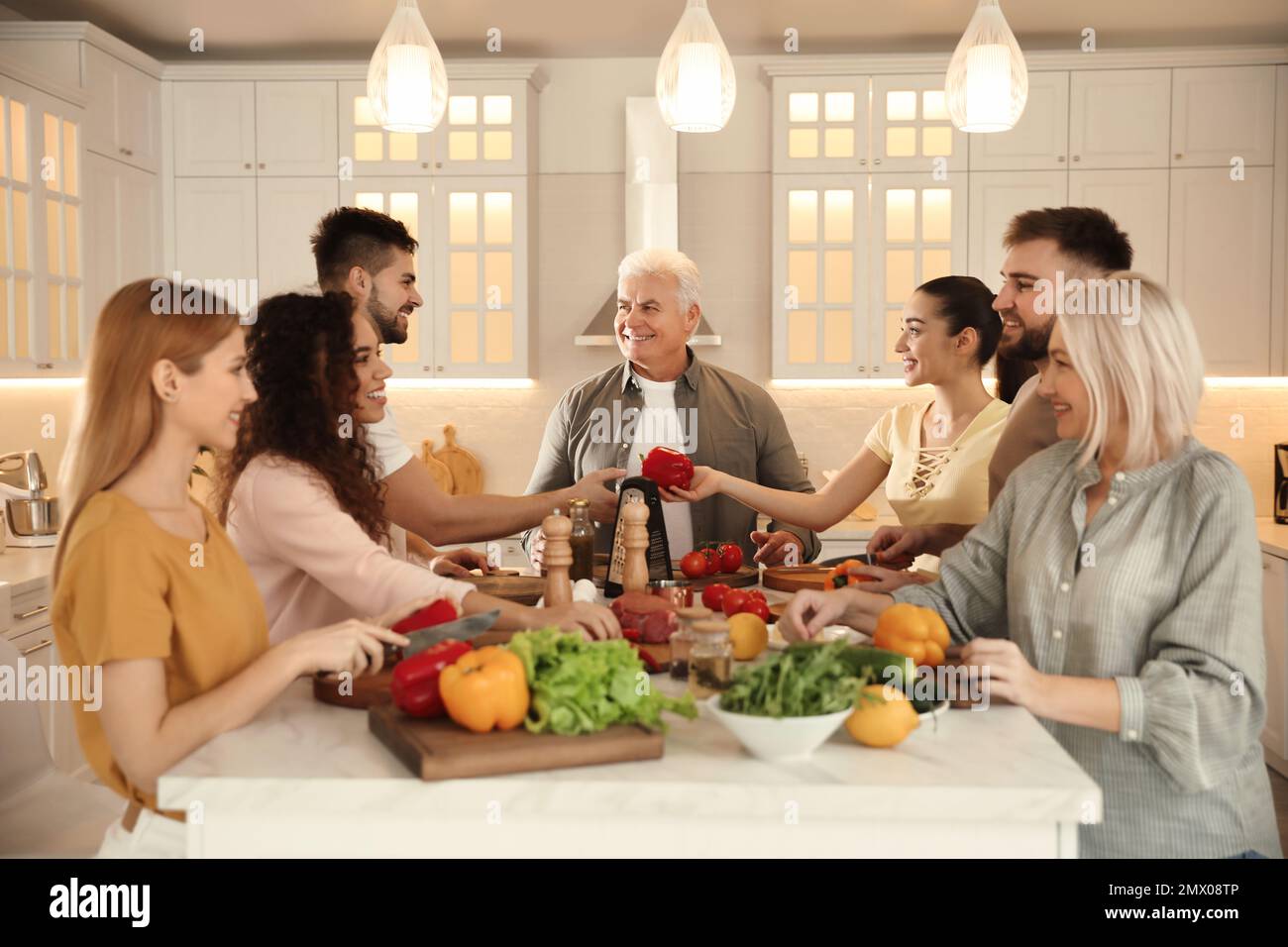 Happy people cooking food together in kitchen Stock Photo - Alamy