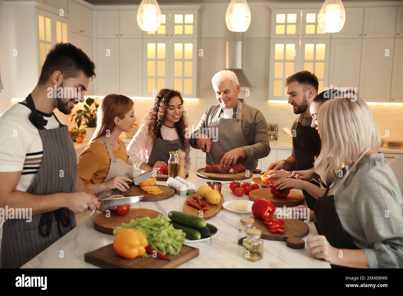 Happy people cooking food together in kitchen Stock Photo - Alamy