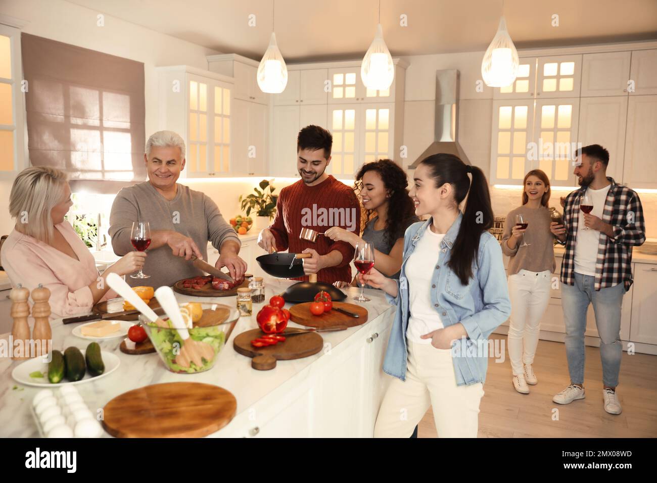 Happy people cooking food together in kitchen Stock Photo - Alamy