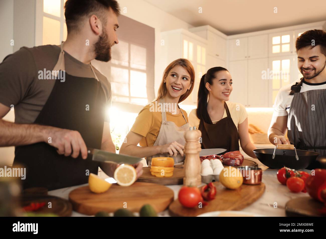 Happy people cooking food together in kitchen Stock Photo - Alamy