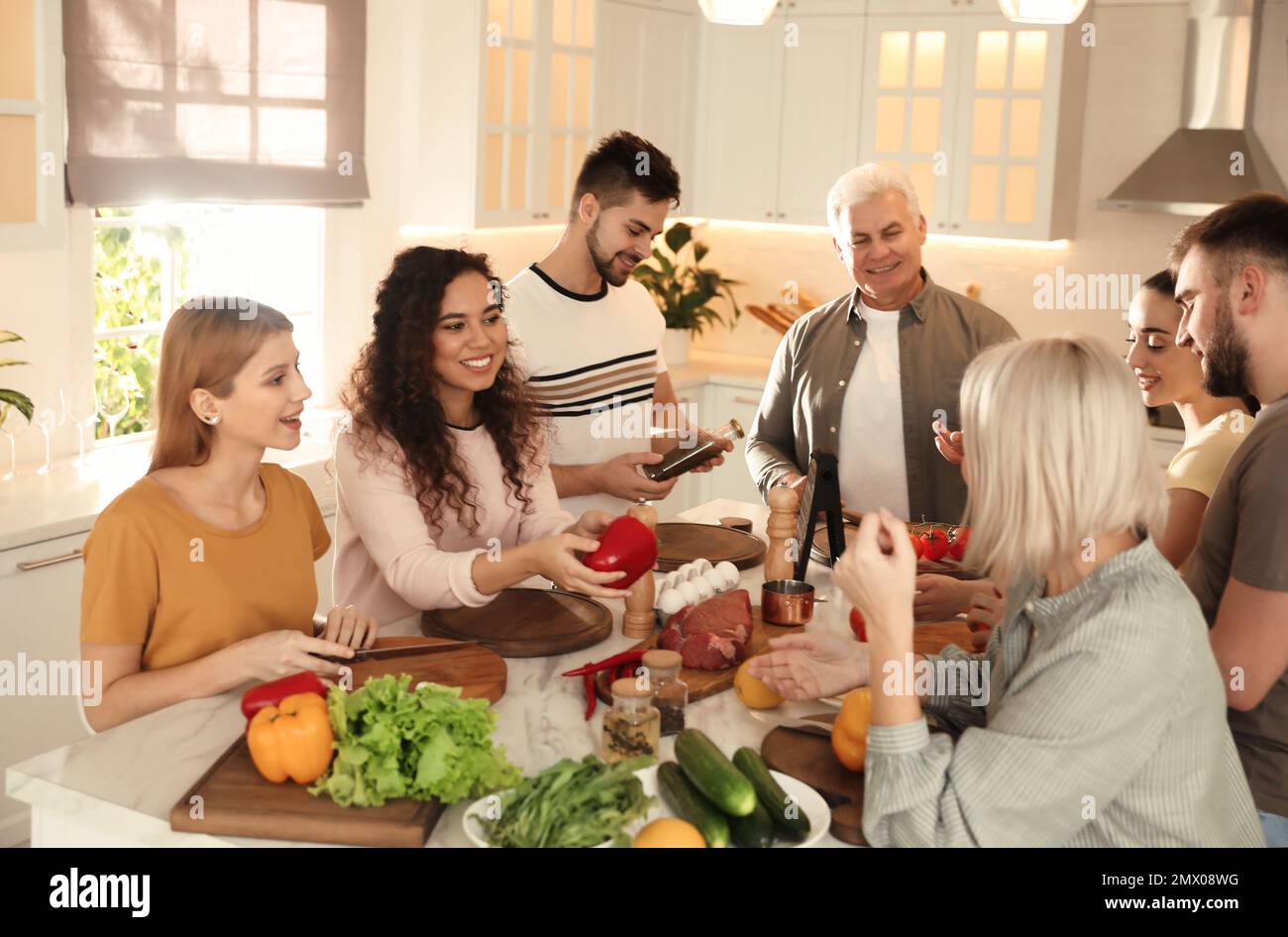 Happy people cooking food together in kitchen Stock Photo - Alamy