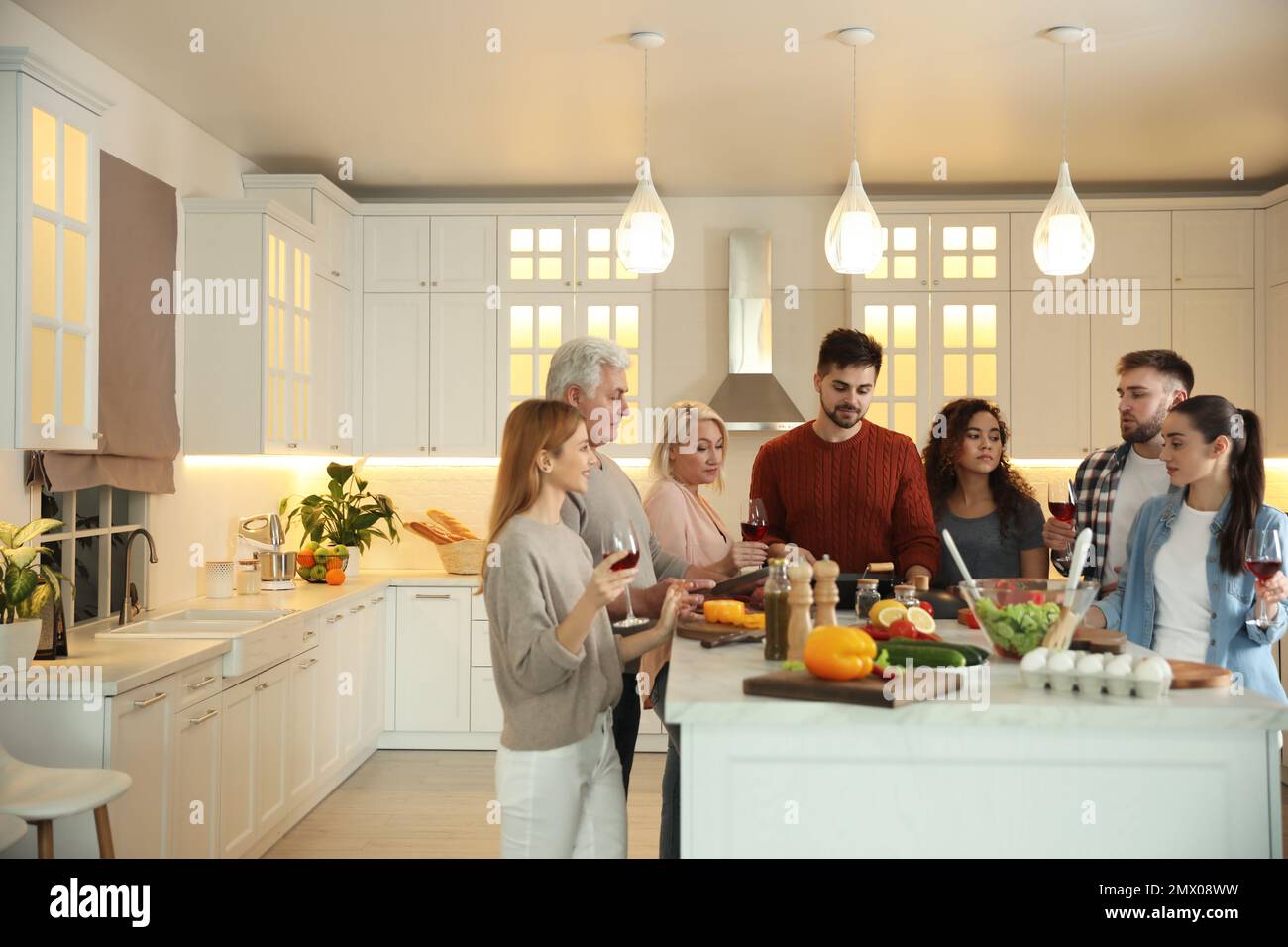 Happy people cooking food together in kitchen Stock Photo - Alamy