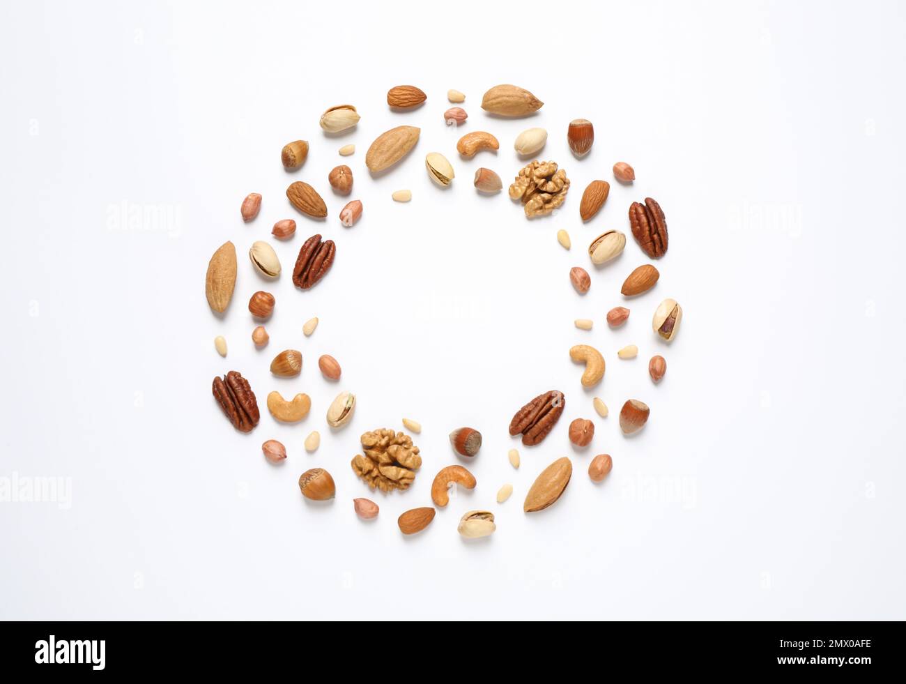 Different delicious nuts on white background, flat lay Stock Photo - Alamy