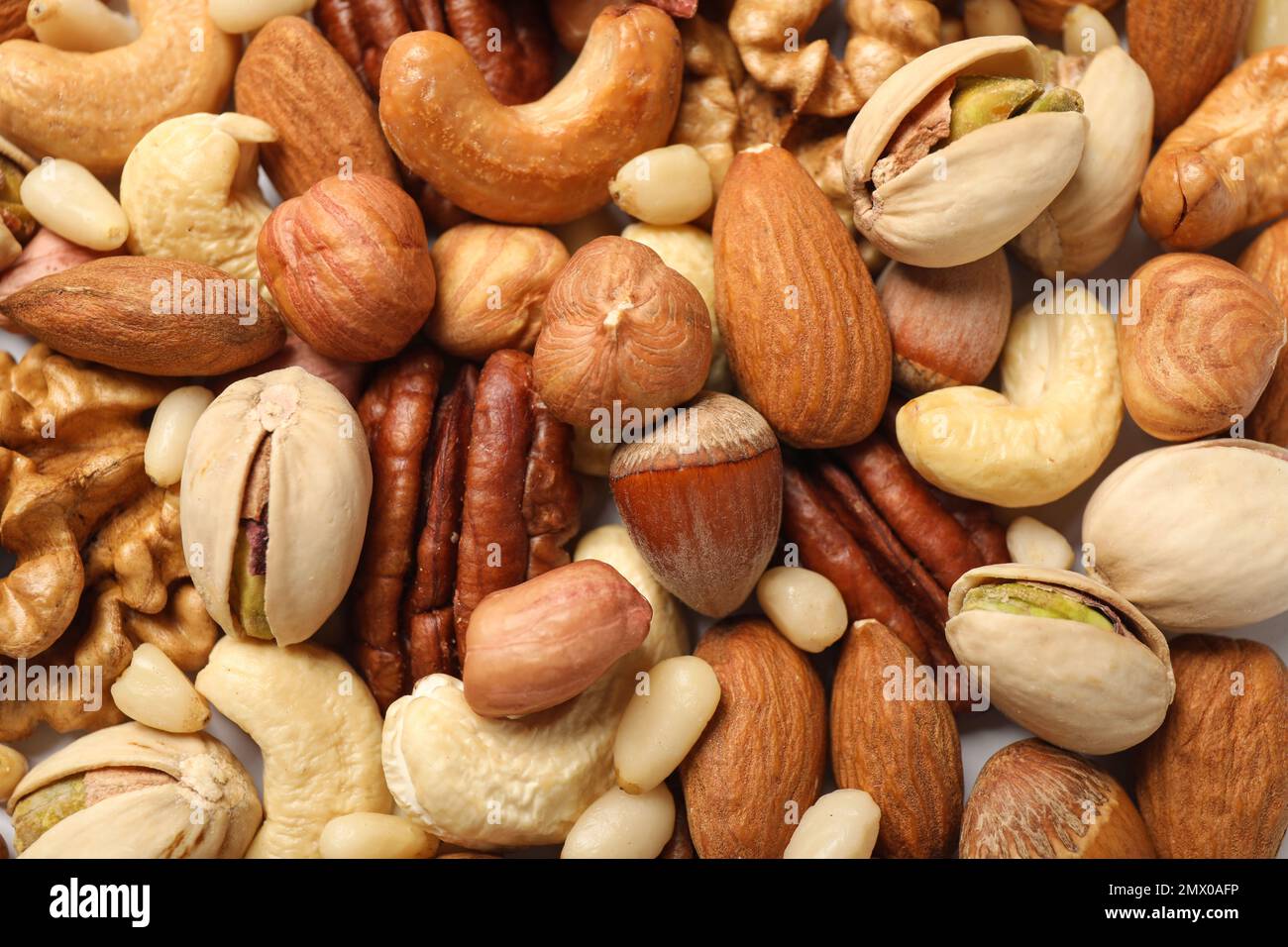 Different delicious nuts as background, closeup view Stock Photo - Alamy